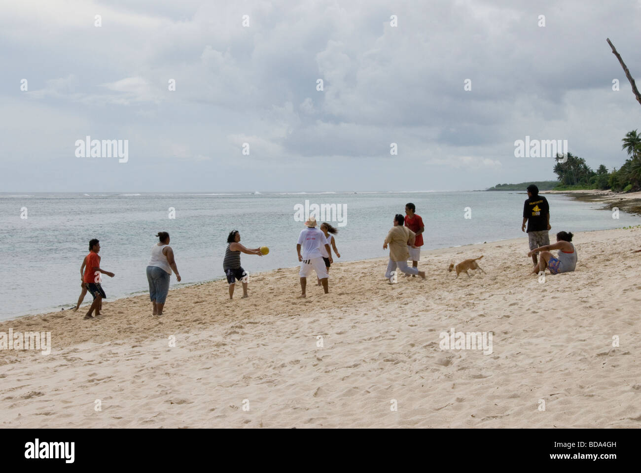 Samoan people playing informal volleyball on beach at Lalomanu Resort ...