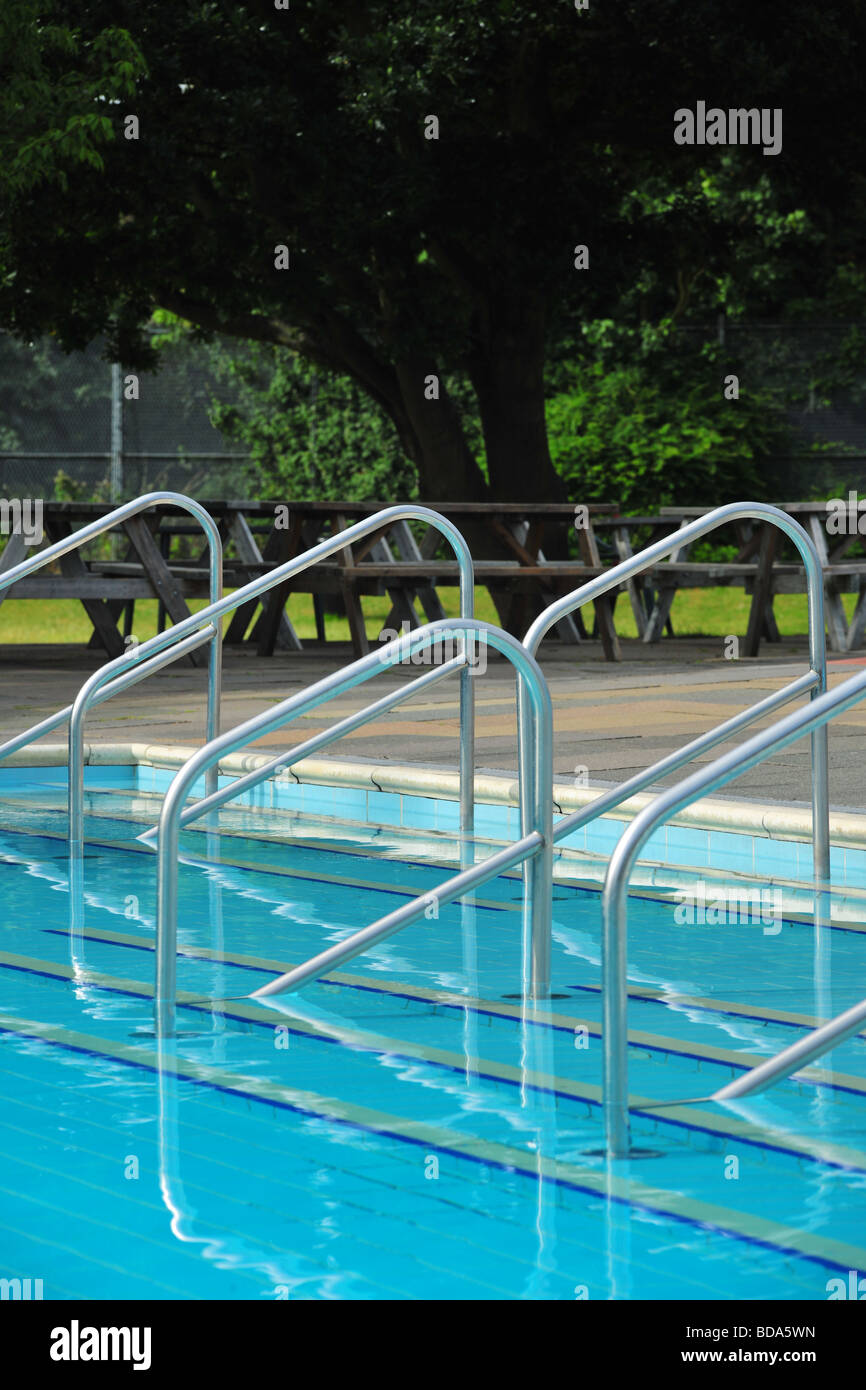 Open air swimming pool with picnic tables behind Stock Photo - Alamy