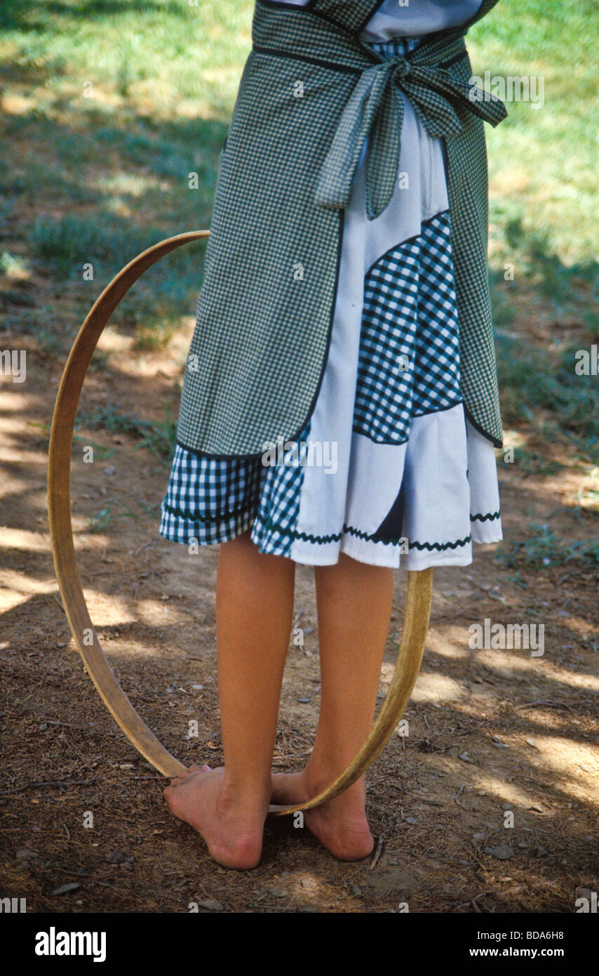 Young girl playing with wooden rolling hoop Stock Photo - Alamy