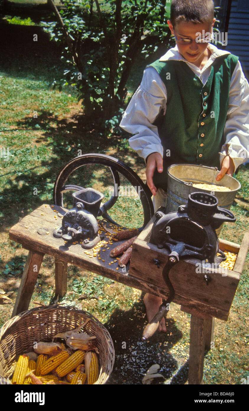 Young boy reenactor displays corn husking machine at Hans Herr house ...