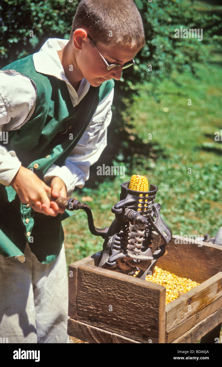 Young boy reenactor displays corn husking machine at Hans Herr house ...