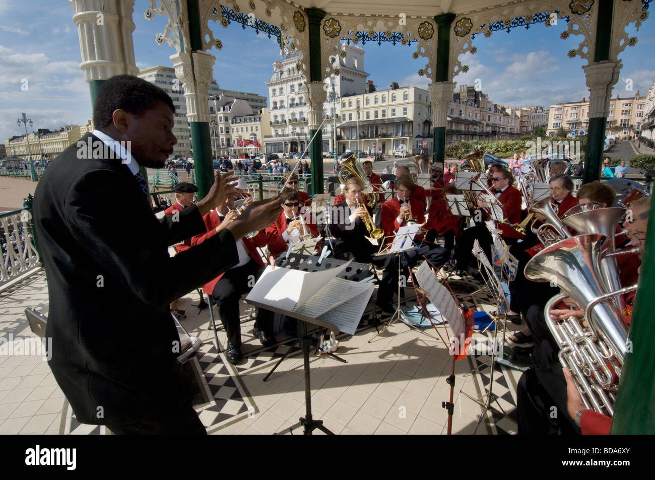 A black conductor leads the Patcham silver band in a concert on ...