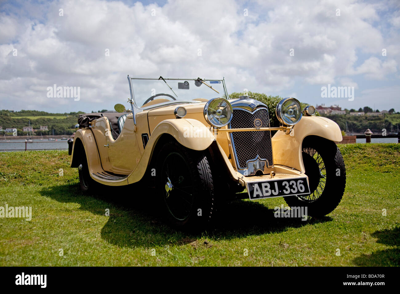 Cream old Vintage car, front radiator grille, chrome and headlights ...