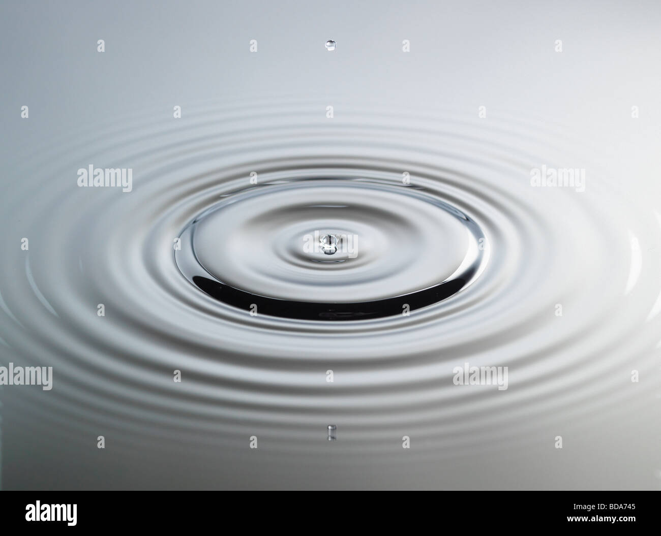 droplet of water with ripples and reflection Stock Photo - Alamy