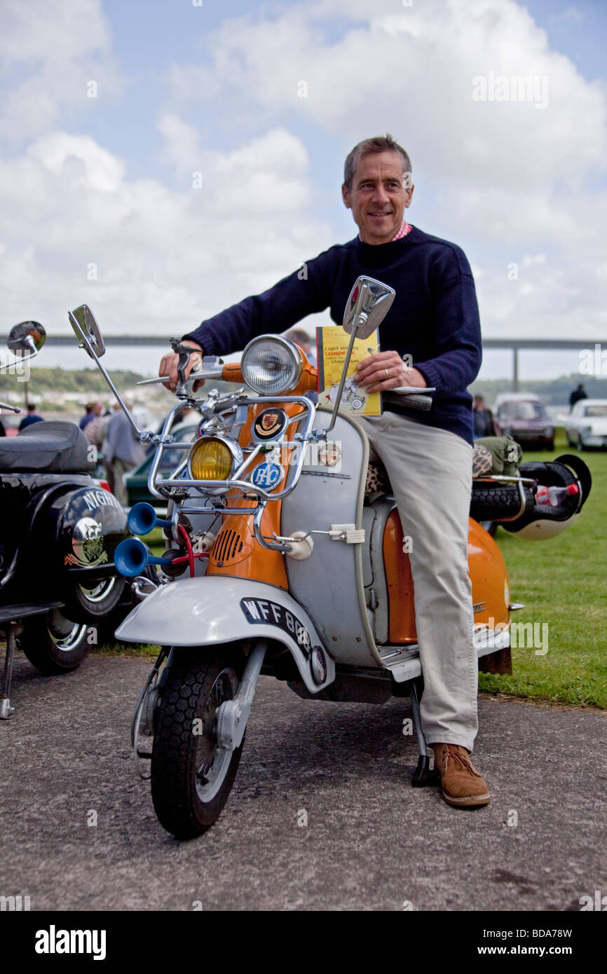 Man on Original orange and Grey Lambretta 1960's motor cycle in show ...