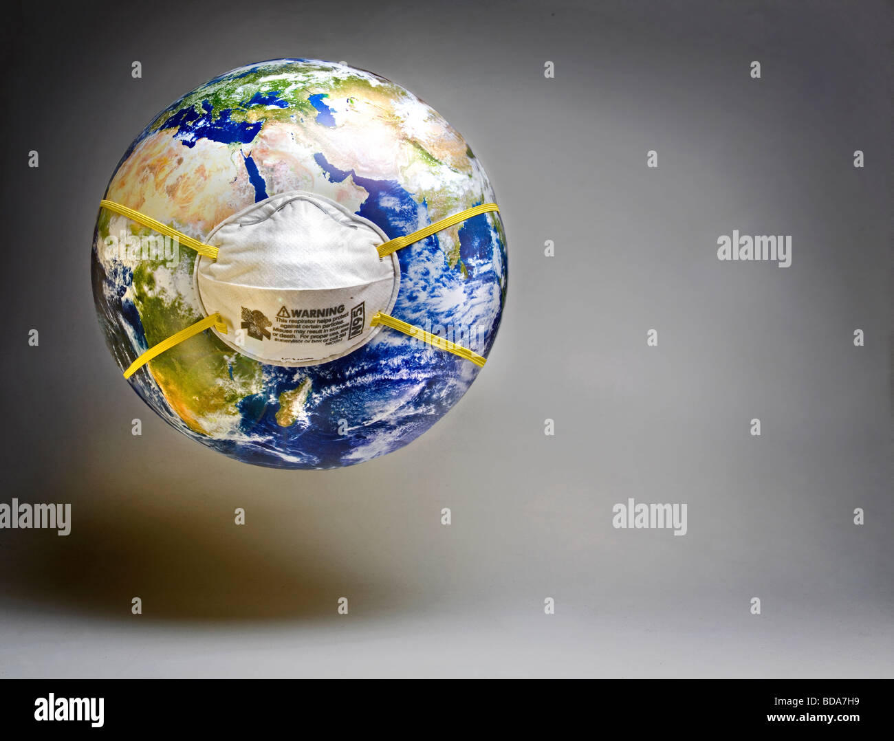 Still shot of a world globe with a breathing mask on it Stock Photo - Alamy