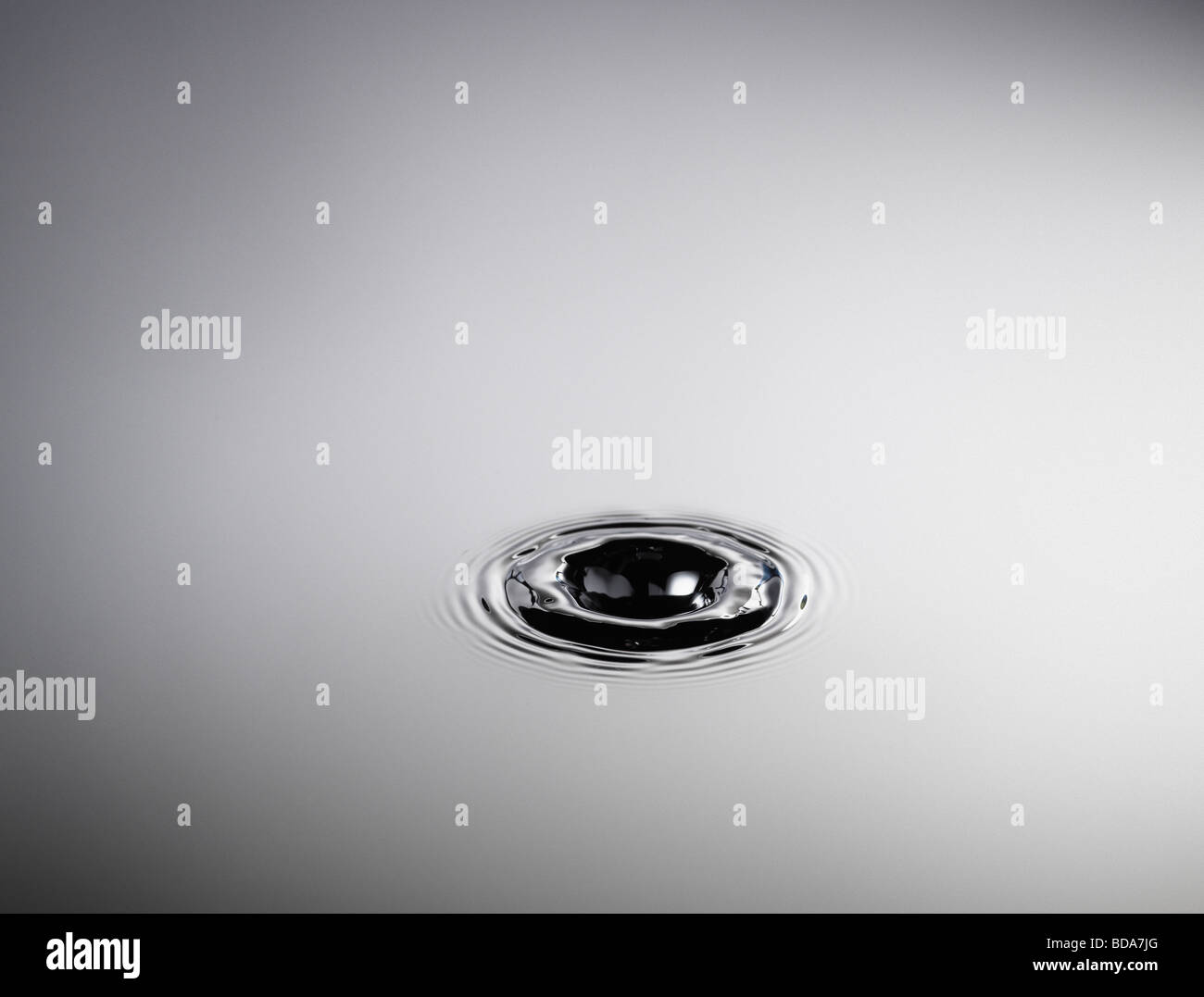 droplet of water with ripples and reflection Stock Photo - Alamy