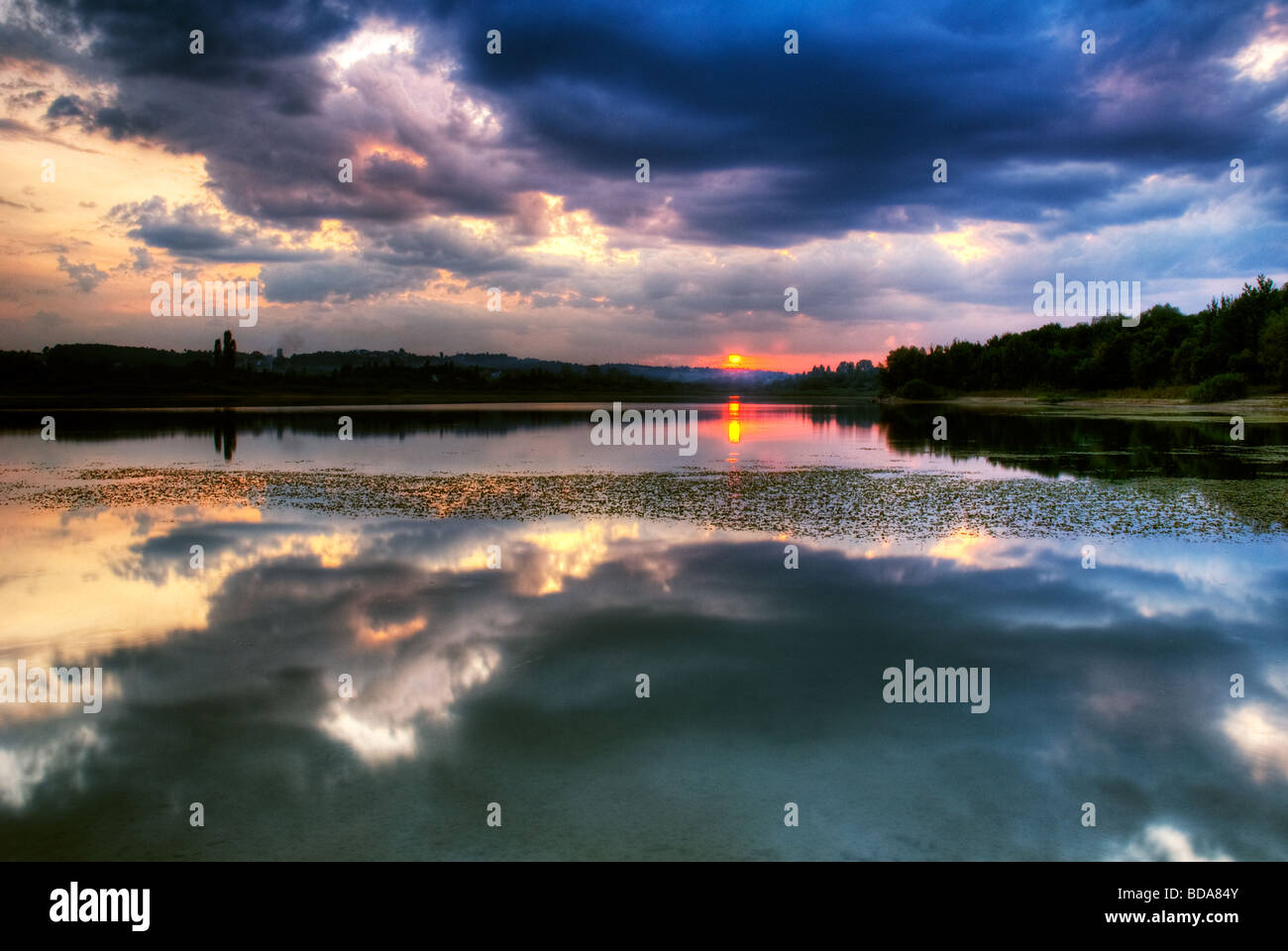 Sunset by the lake Stock Photo - Alamy