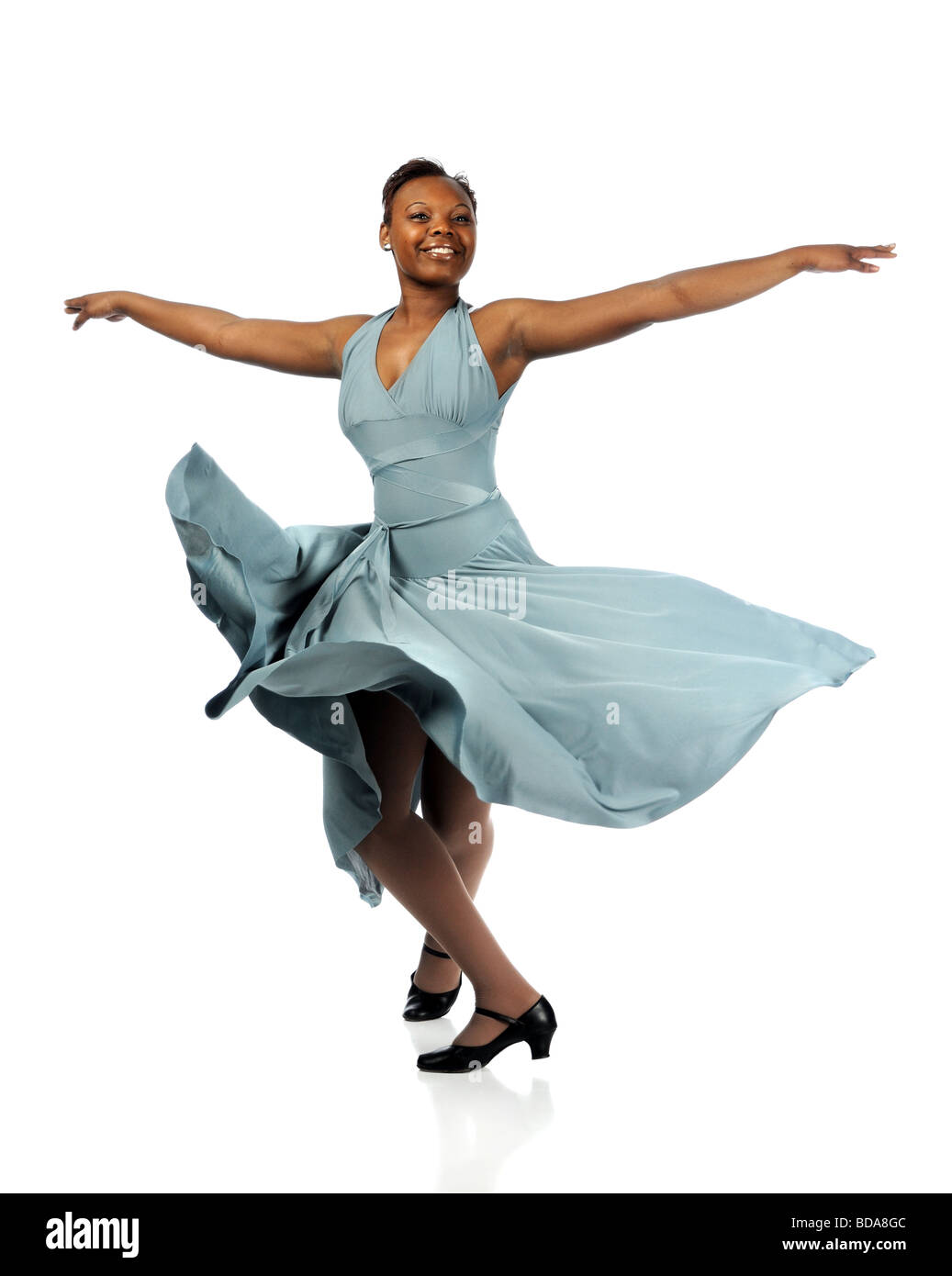 Beautiful African American woman dancing with dress blowing over white ...