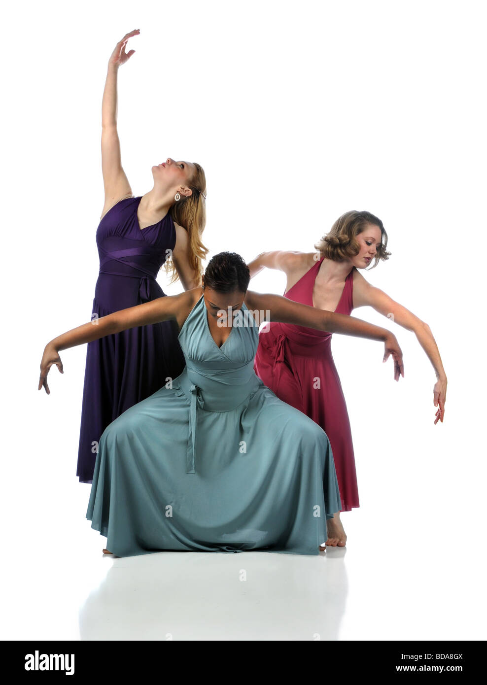 Three dancers performing isolated over white background Stock Photo - Alamy