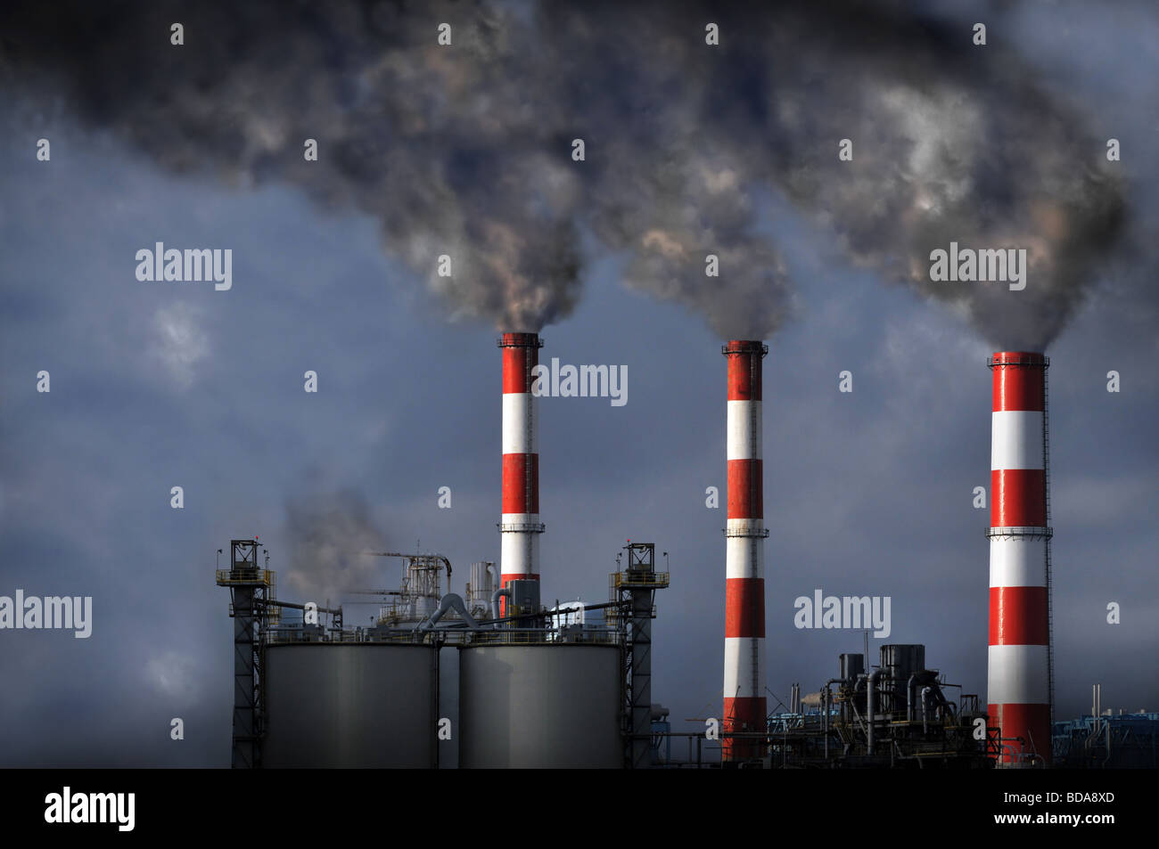 Industrial smokestacks blowing dark smoke into the atmosphere Stock ...