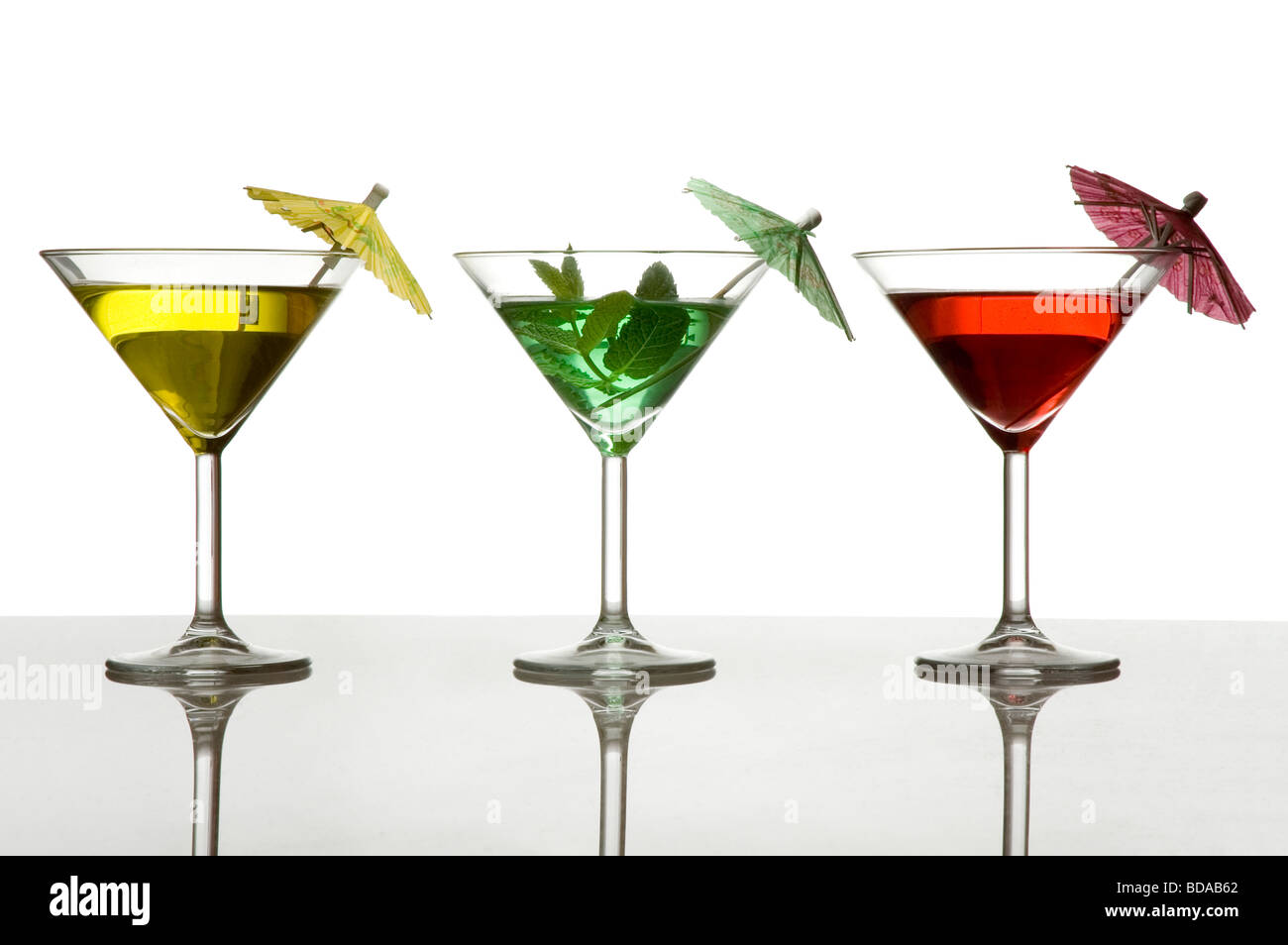 three cocktails with umbrella isolated on a white background Stock ...