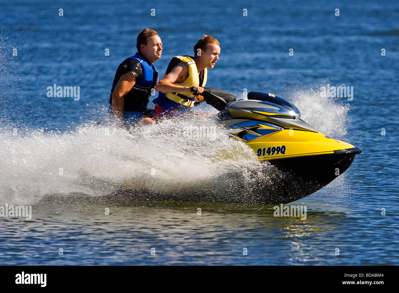 Jetski riders riding leisure sport activity water Stock Photo - Alamy