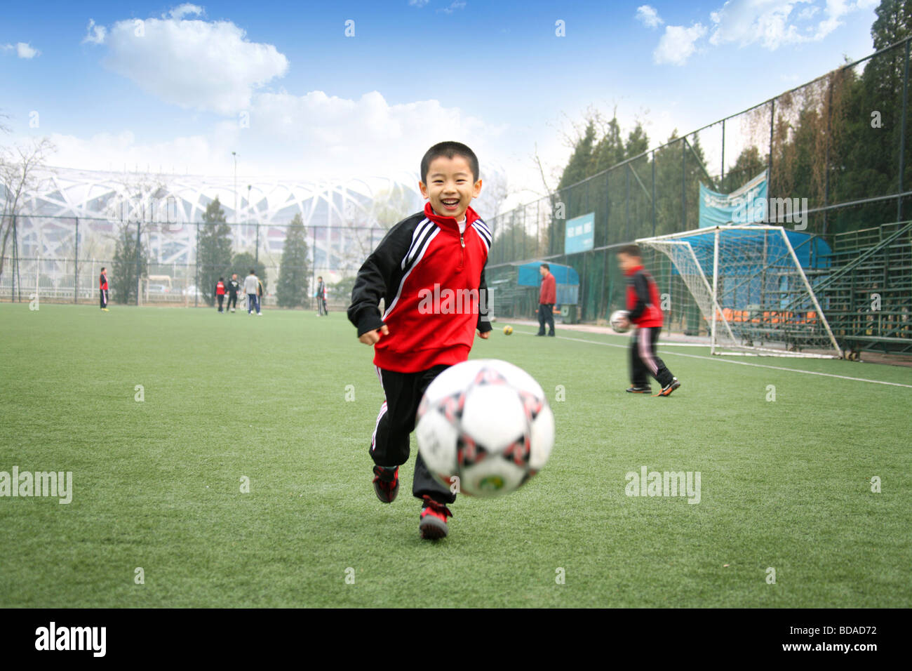 Chinese boy playing soccer on the field Stock Photo - Alamy