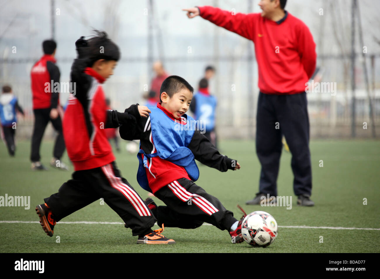 Chinese boy playing soccer on the field Stock Photo - Alamy