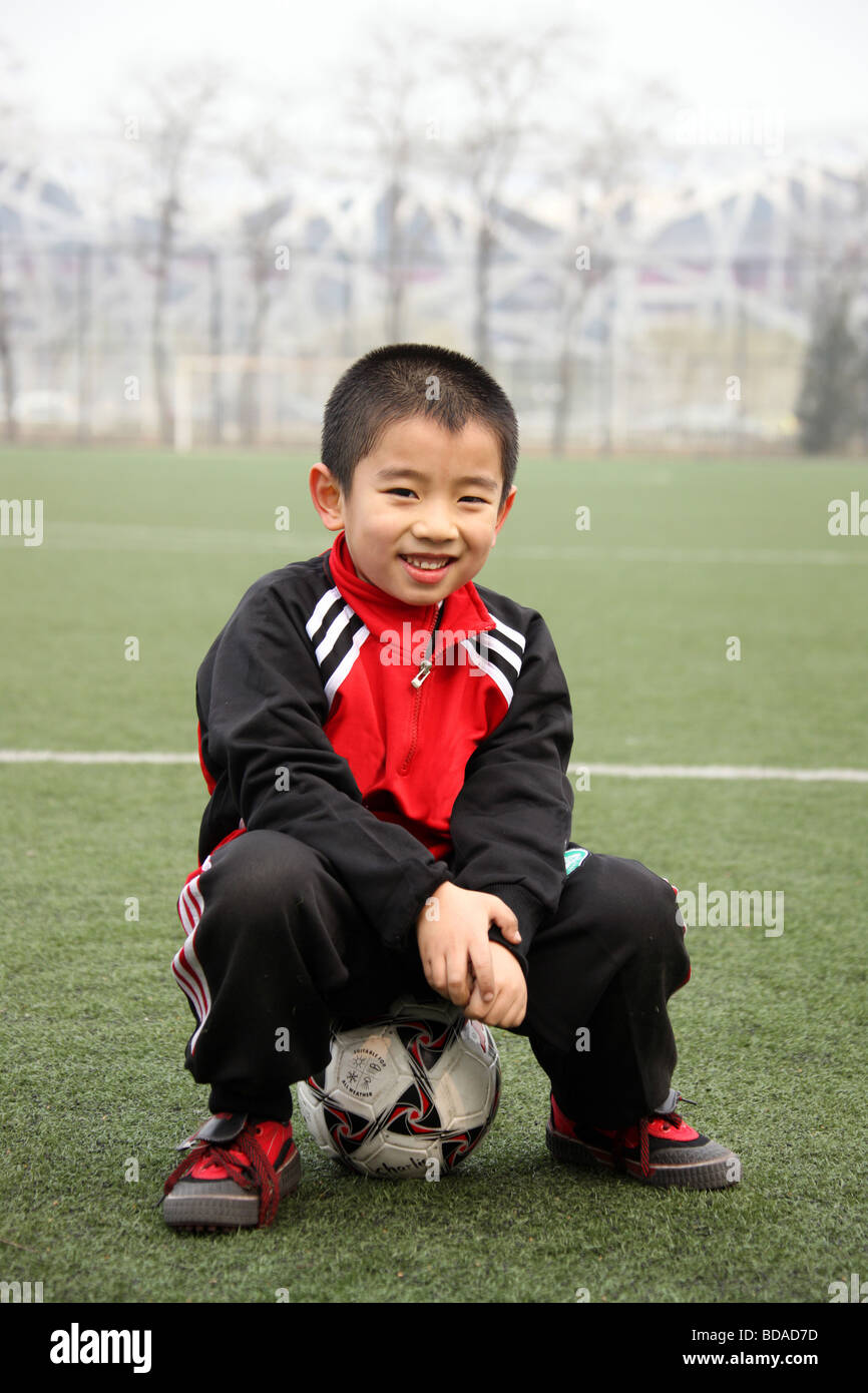 Chinese boy playing soccer on the field Stock Photo - Alamy