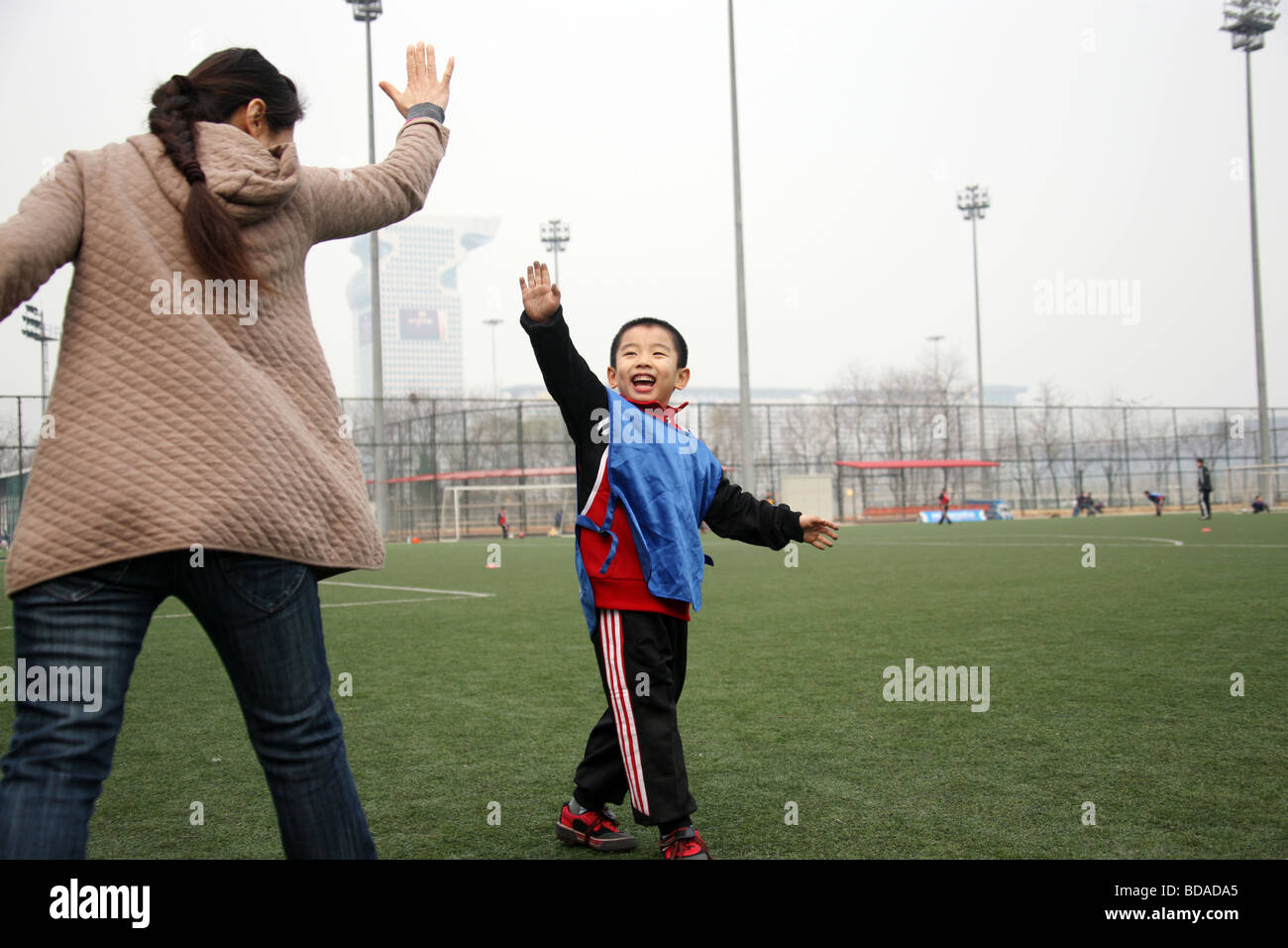 Chinese boy playing soccer on the field Stock Photo - Alamy