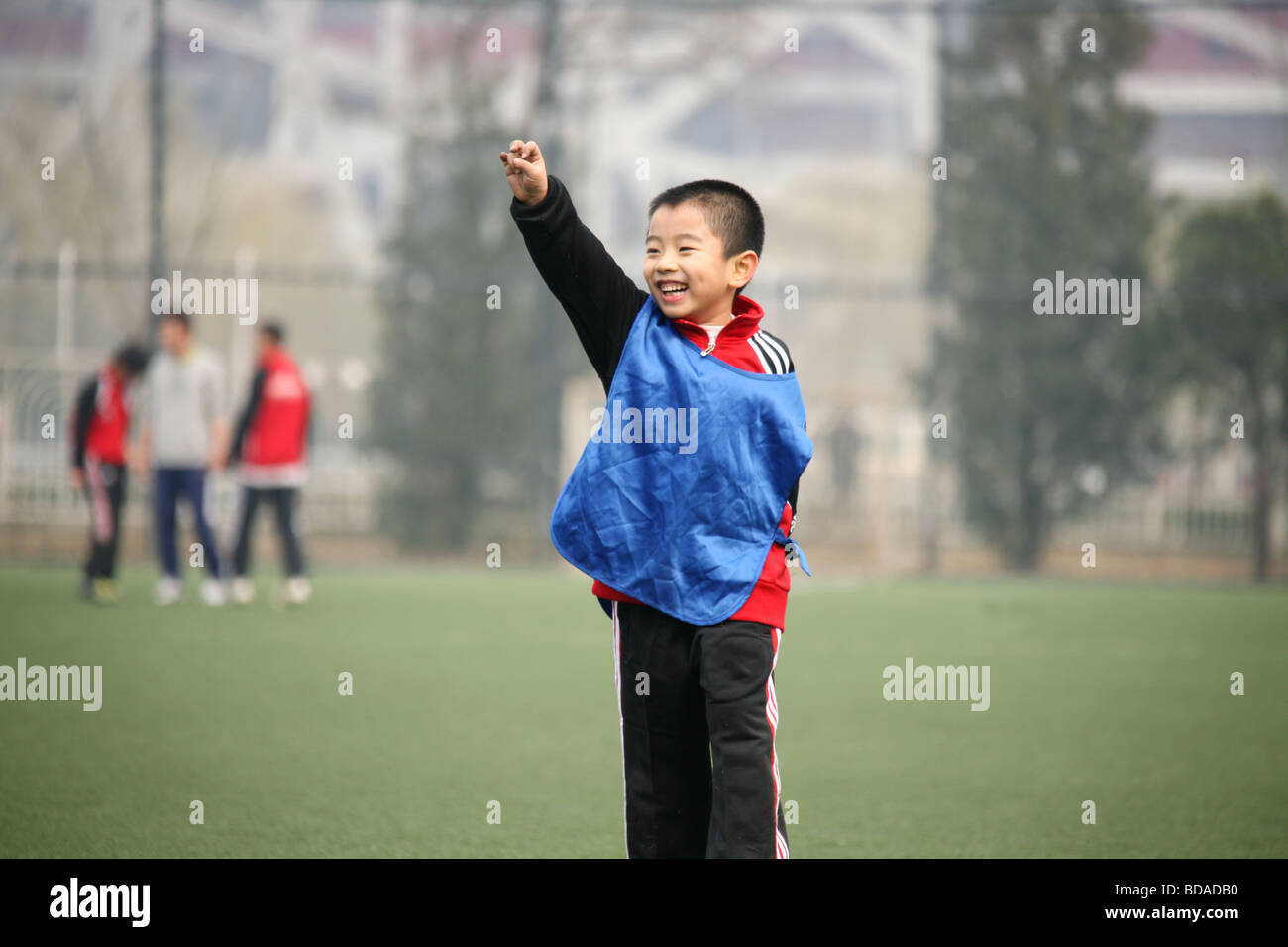 Chinese boy playing soccer on the field Stock Photo - Alamy
