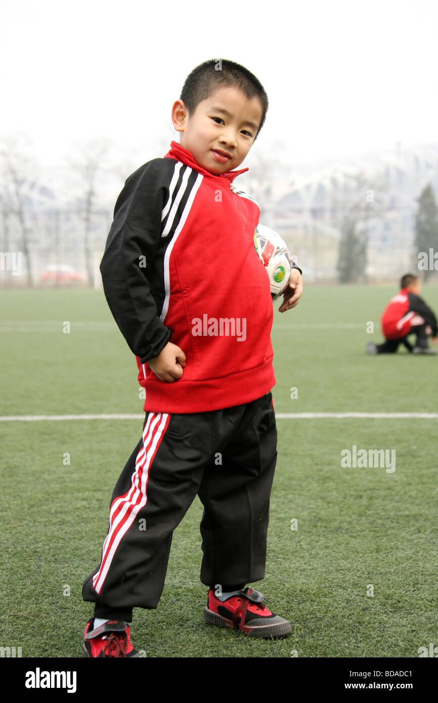 Chinese boy playing soccer on the field Stock Photo - Alamy