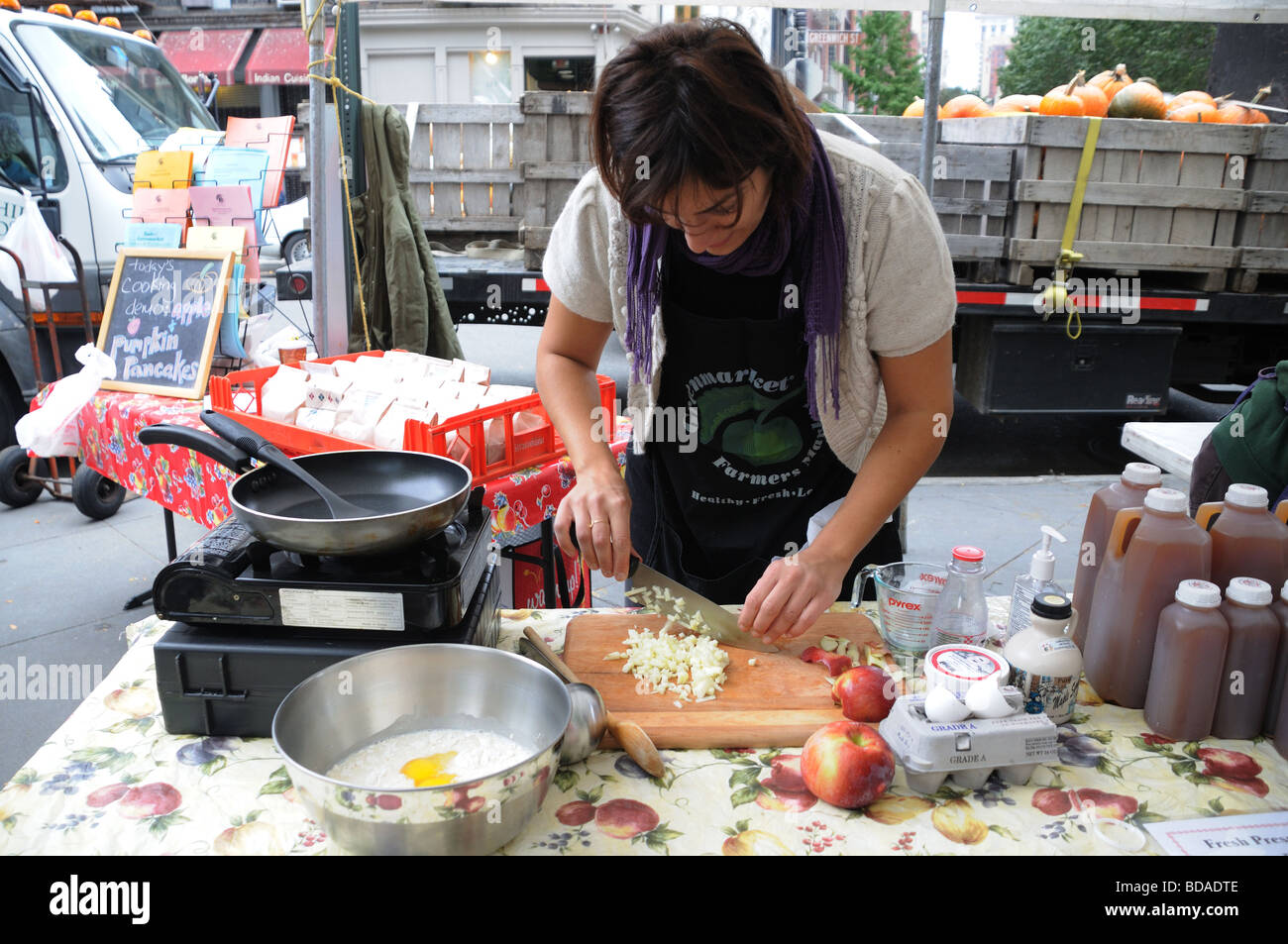 A farmers' market employee demonstrates how to cook apple and pumpkin ...