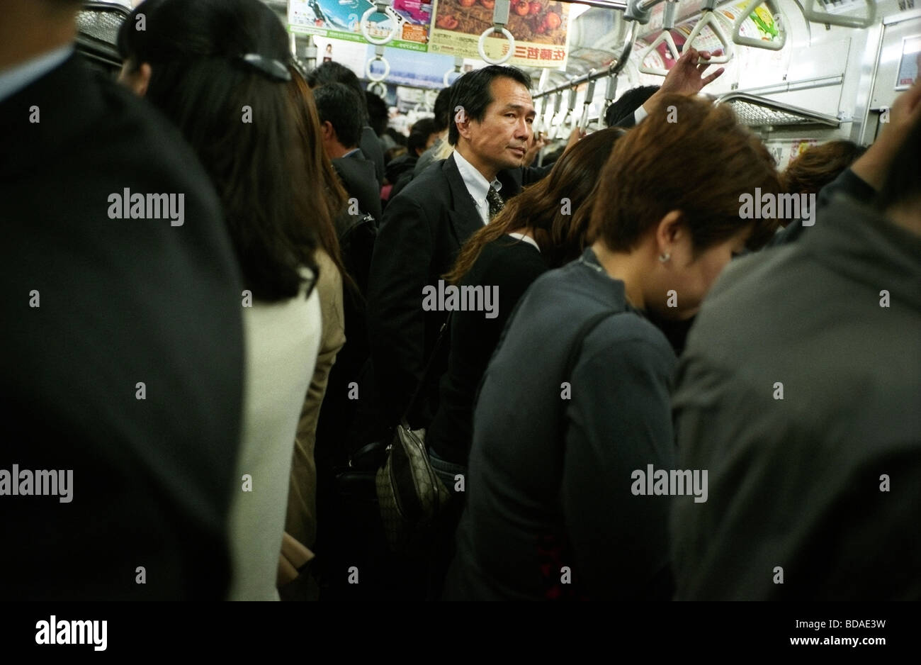 Commuters are seen standing shoulder to shoulder on a train in Tokyo ...