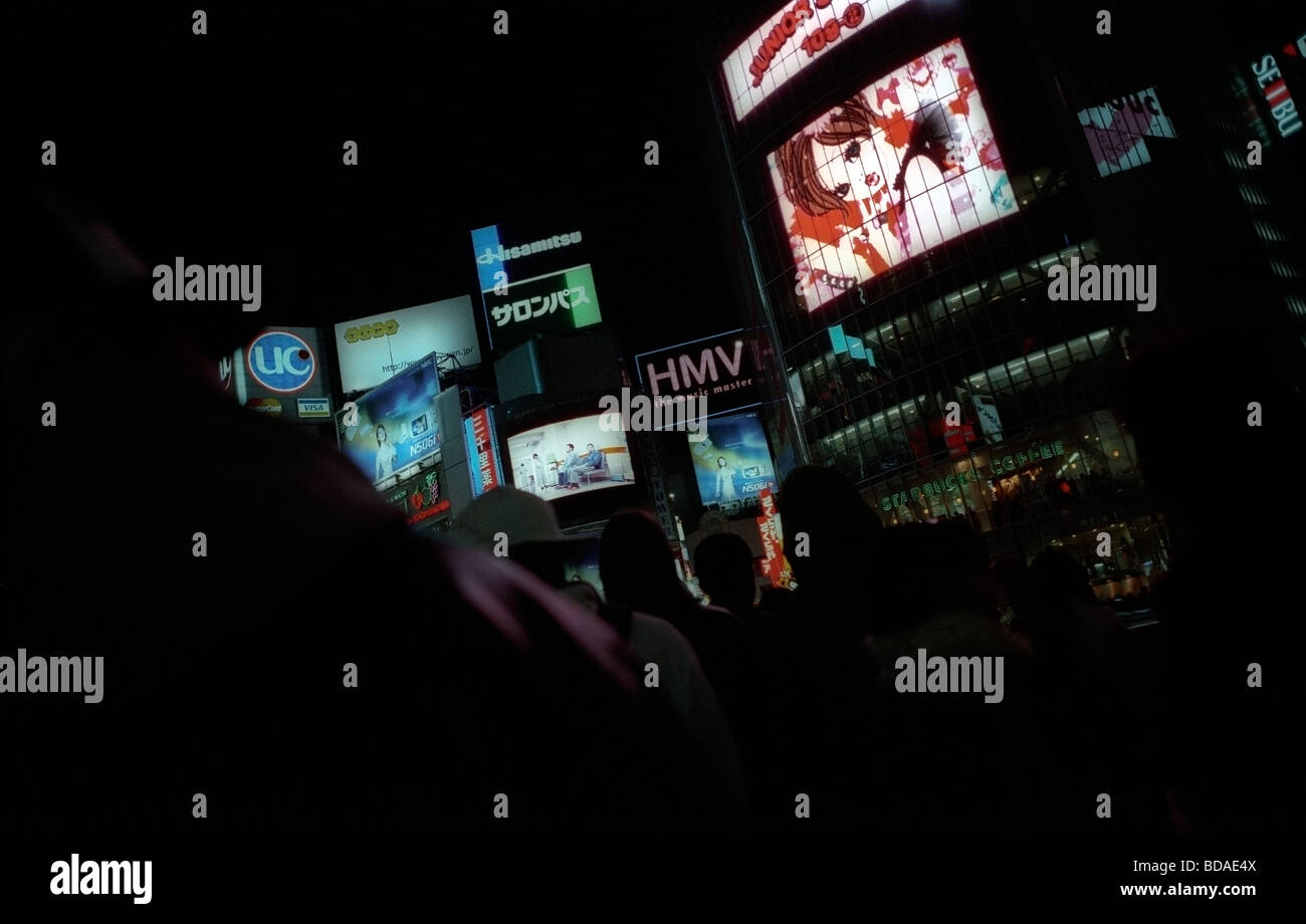 A large screen showing an anime figure is seen at the Shibuya crossing ...