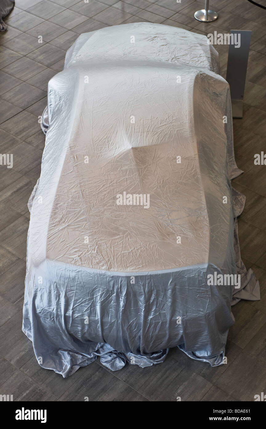New Car covered with sheet prior to new model launch Stock Photo - Alamy