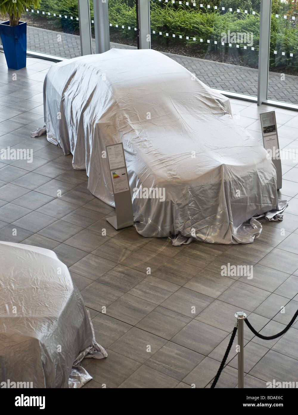 New Car covered with sheet prior to new model launch Stock Photo - Alamy