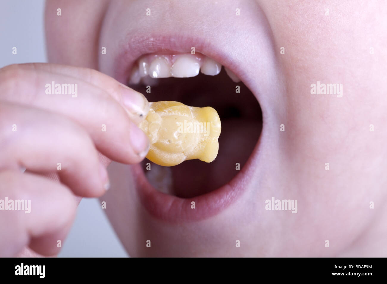 close up shot of child about to eat a jelly baby Stock Photo - Alamy
