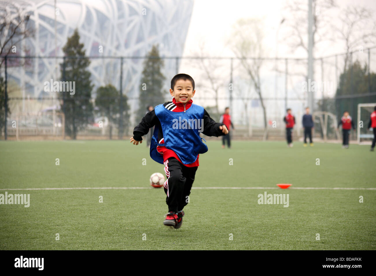 Chinese boy playing soccer on the field Stock Photo - Alamy