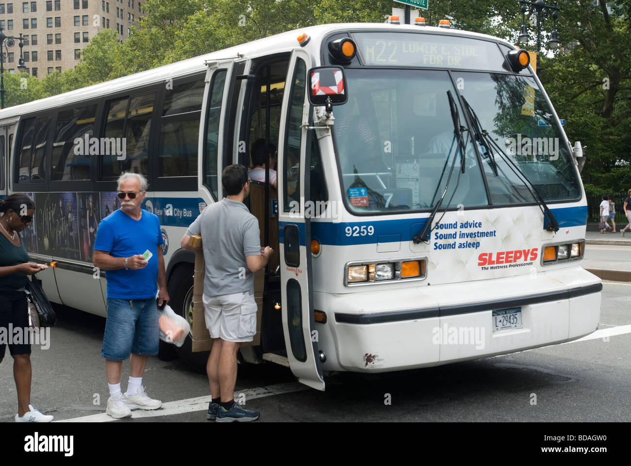 People board the M22 bus near City hall in the New York on Saturday ...