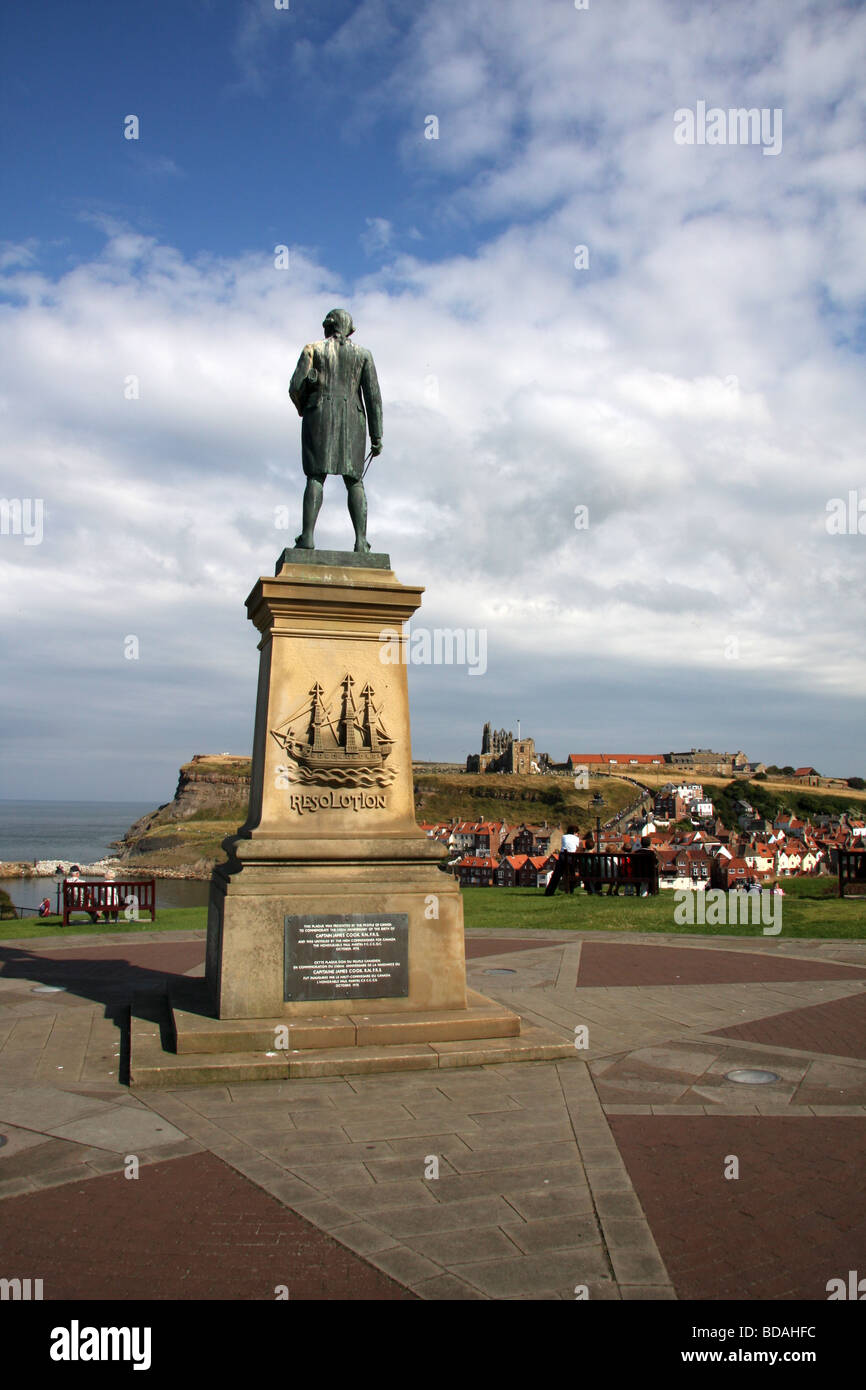 Captain James Cook statue with St. Hilda's church and Whitby Abbey in ...