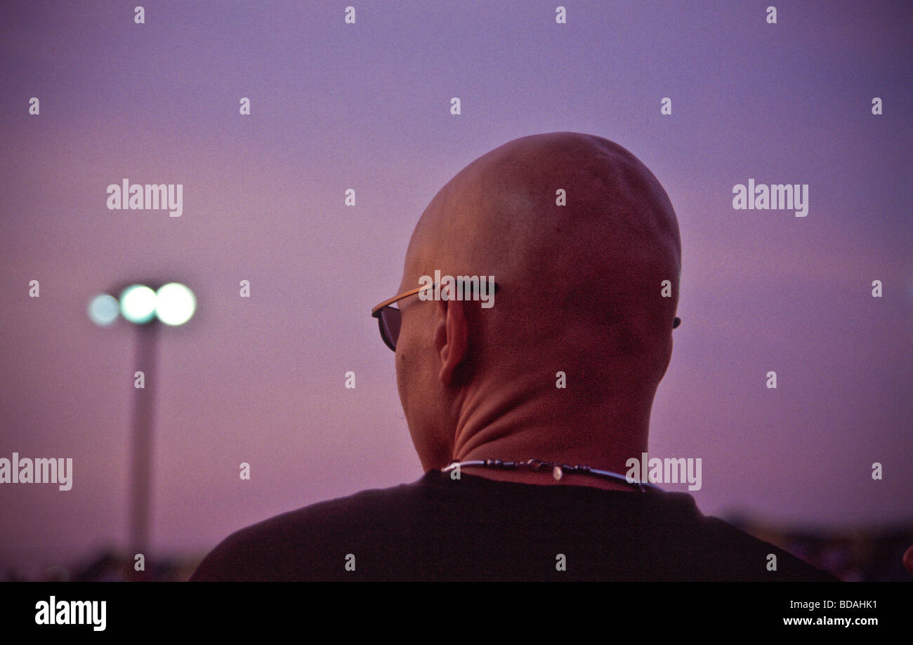 Bald headed man at county fair watching rodeo Stock Photo - Alamy