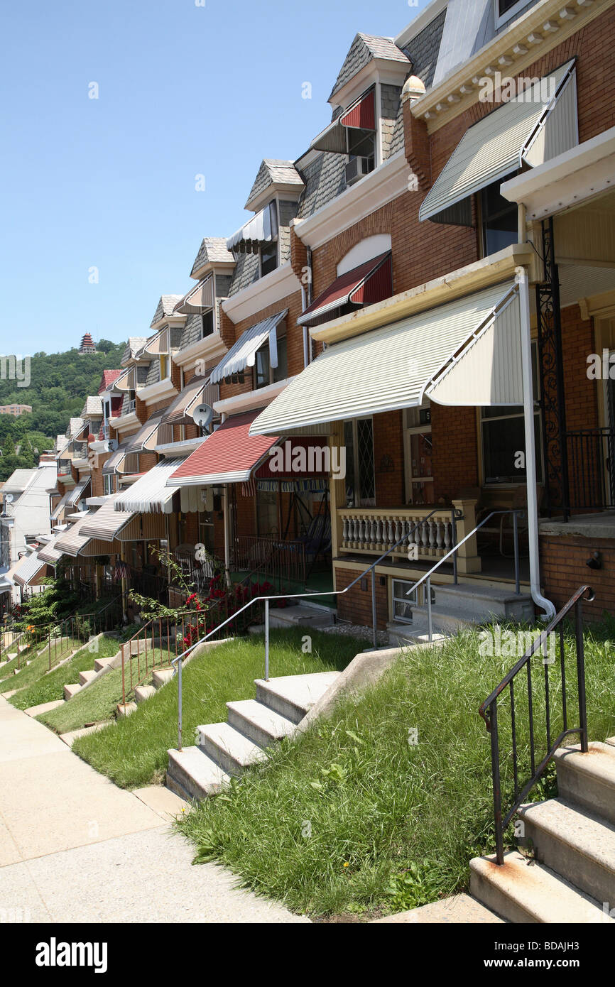 Section of row of Victorian style terraced houses descending steep ...