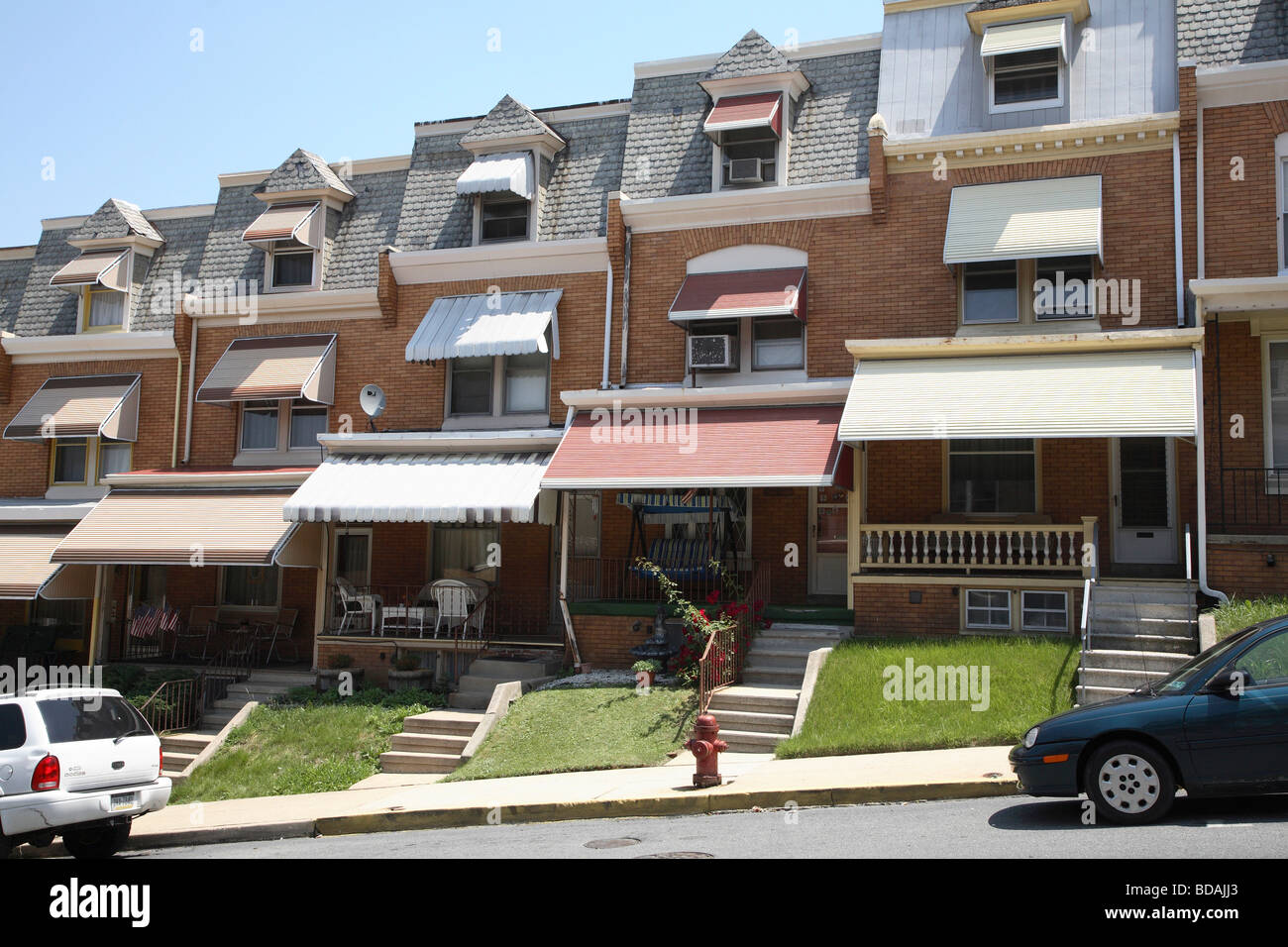 Section of row of Victorian style terraced houses built on hillside ...