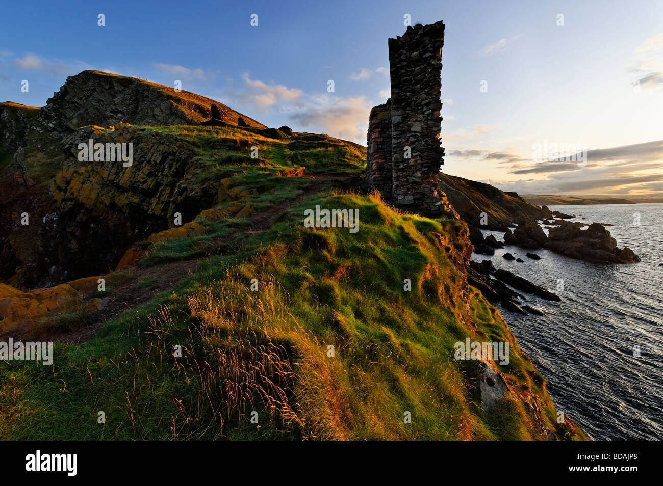 Evening light on the ruins of Fast Castle on the Berwickshire coast in ...