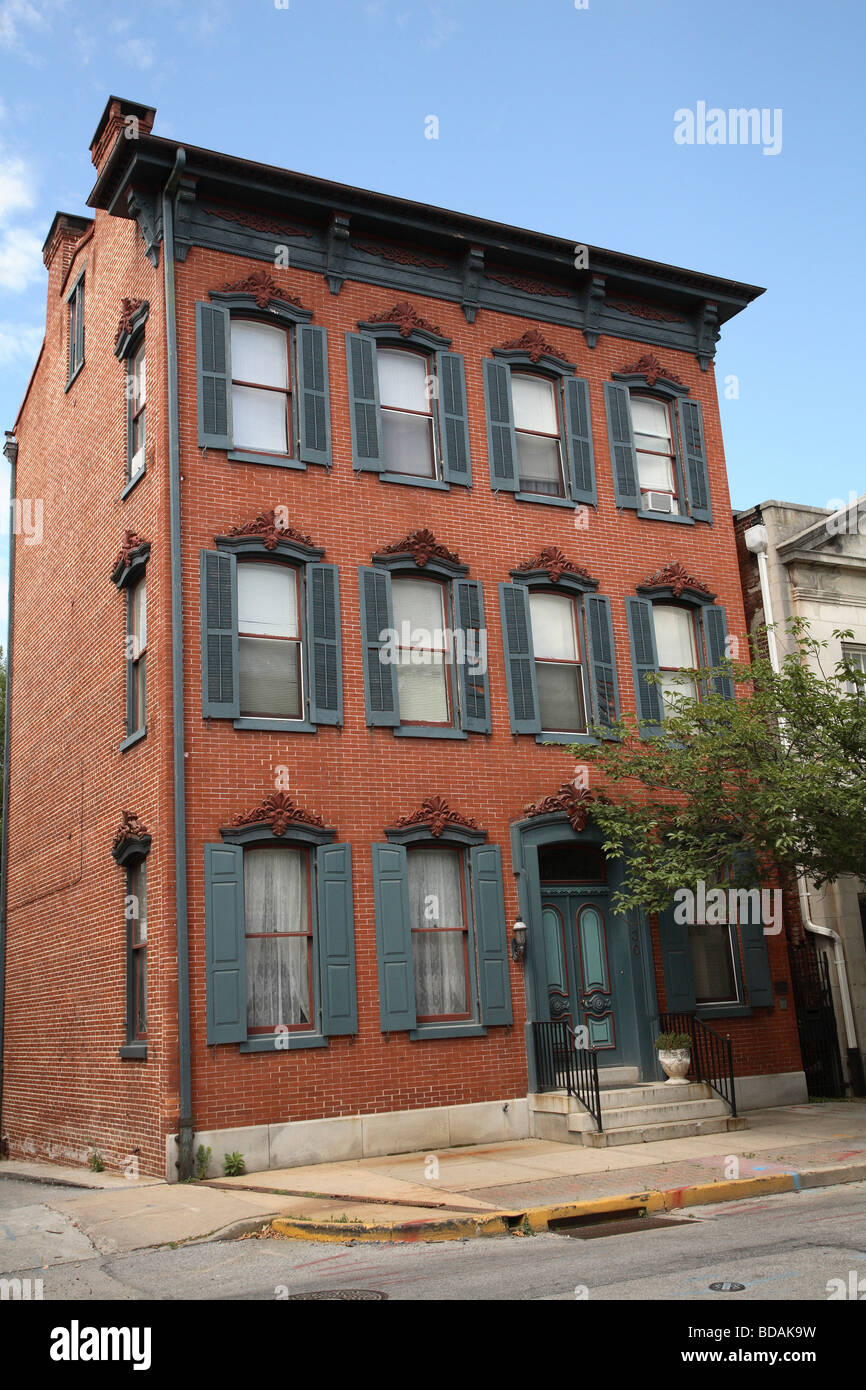 Three story red brick building with decorative Italianate frontage ...
