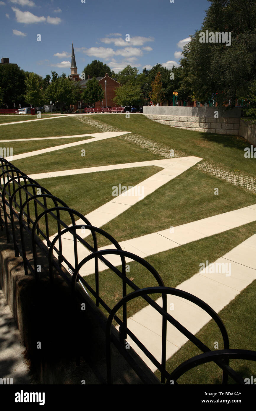 Bright white zig zag concrete flagstone path ascends slope of short ...
