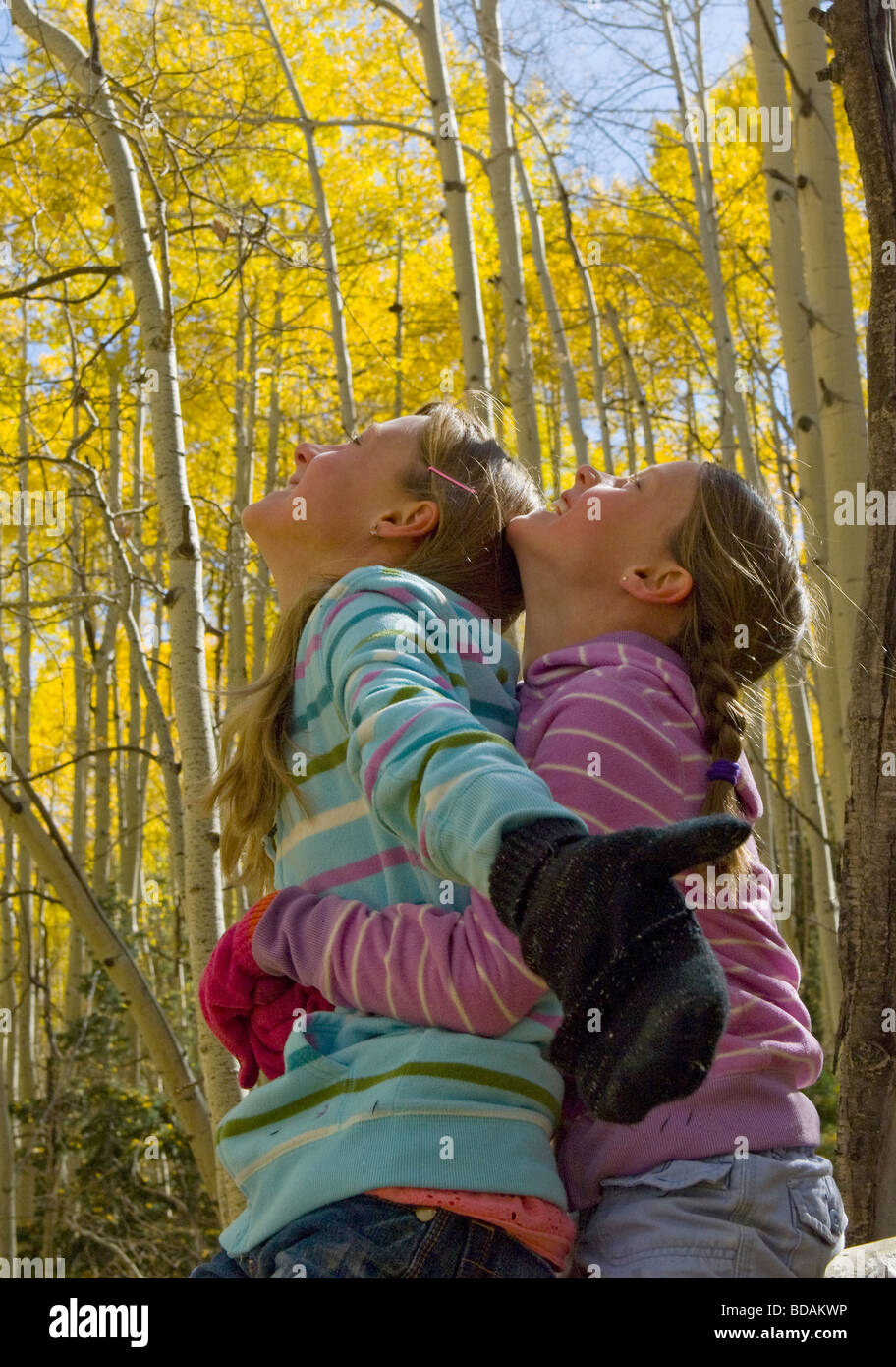 Sisters playing in fall colors Stock Photo - Alamy