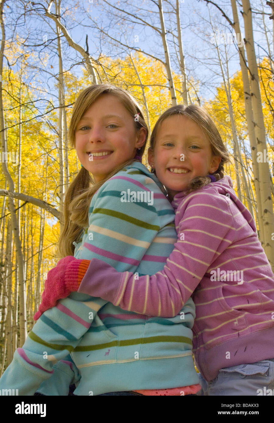 Sisters playing in fall colors Stock Photo - Alamy