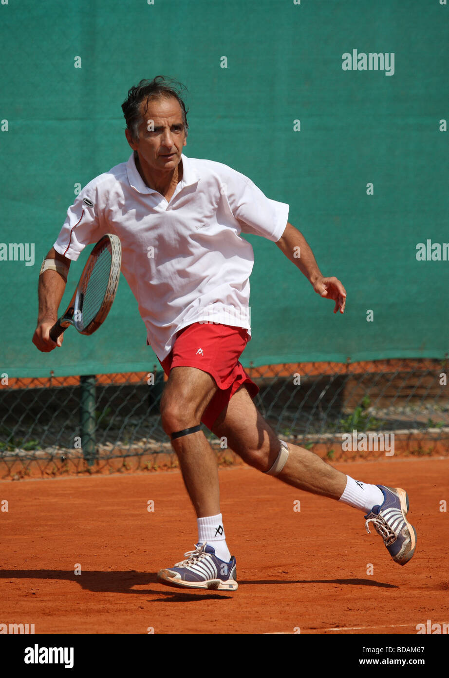Elderly man playing at a tennis tournament Stock Photo - Alamy