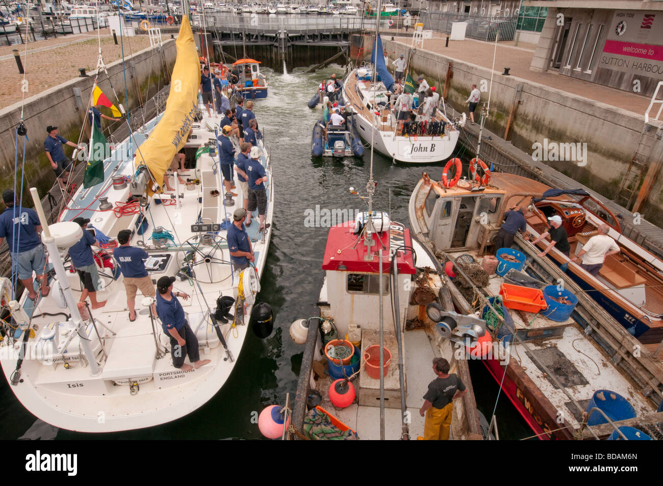 Yachts from the Rolex Fastnet race 2009 wait along side fishing boats ...