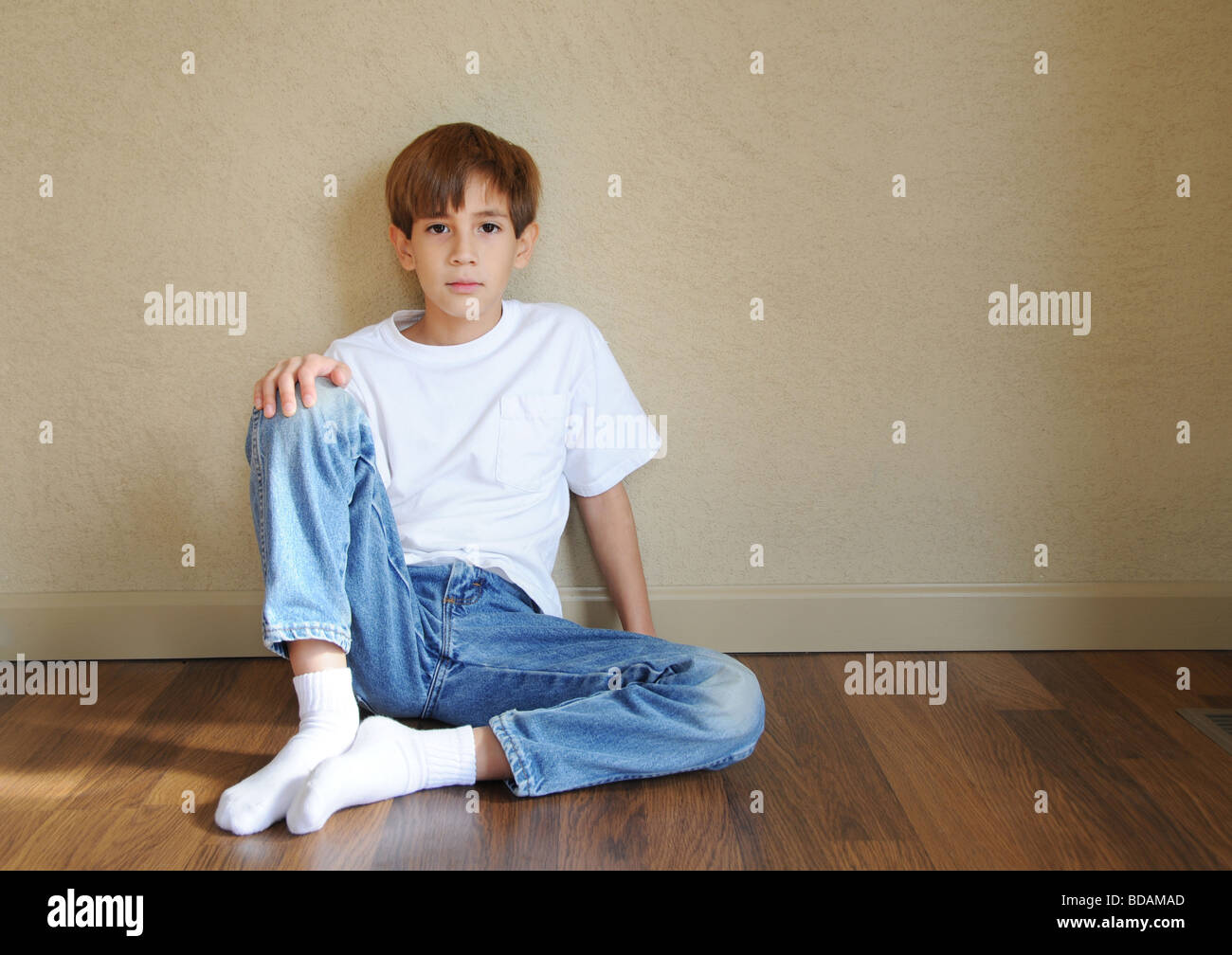 Boy seating on the floor Stock Photo - Alamy