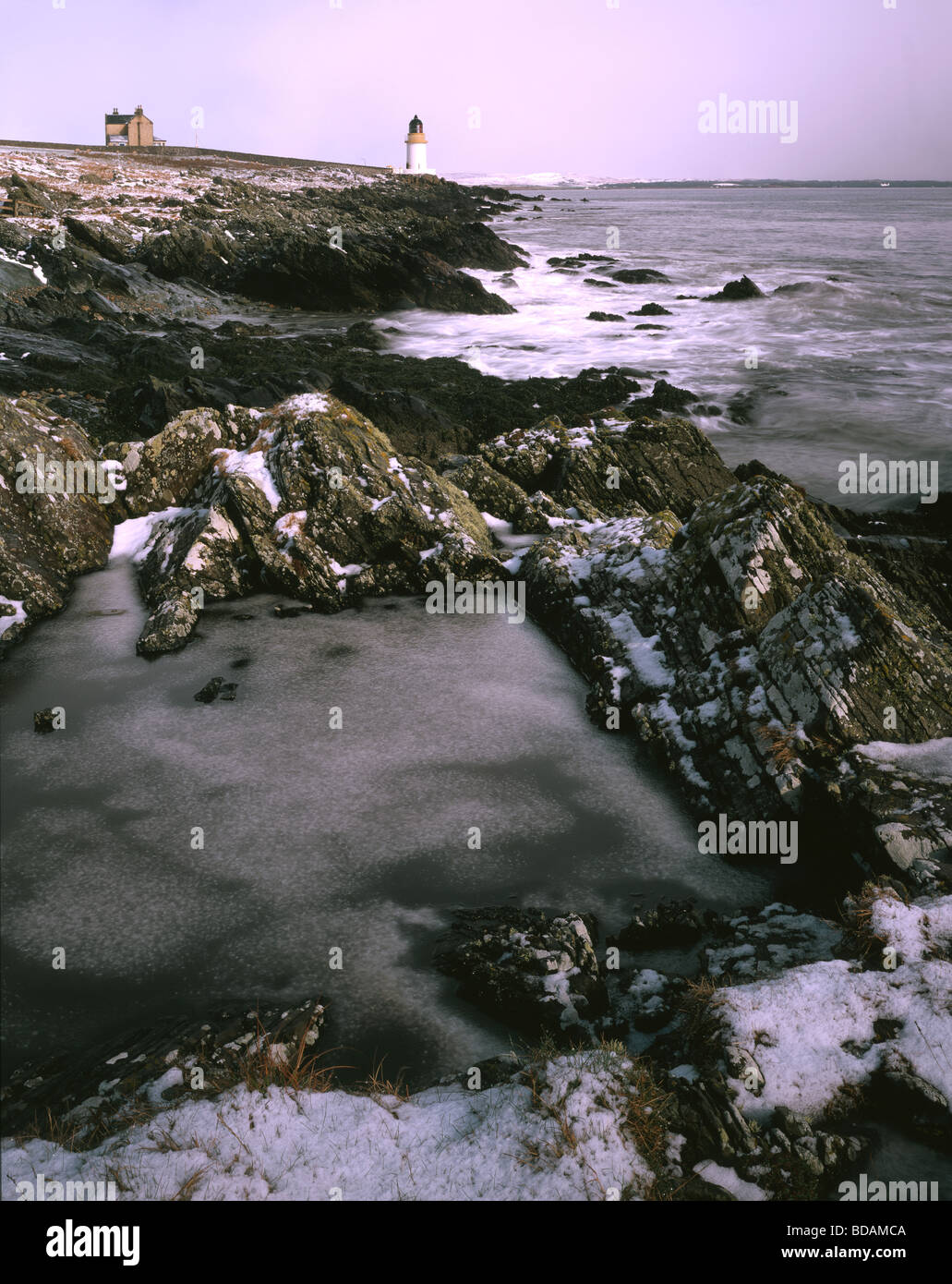 Spring snow on the shoreline at Port Charlotte, Isle of Islay, Scotland ...