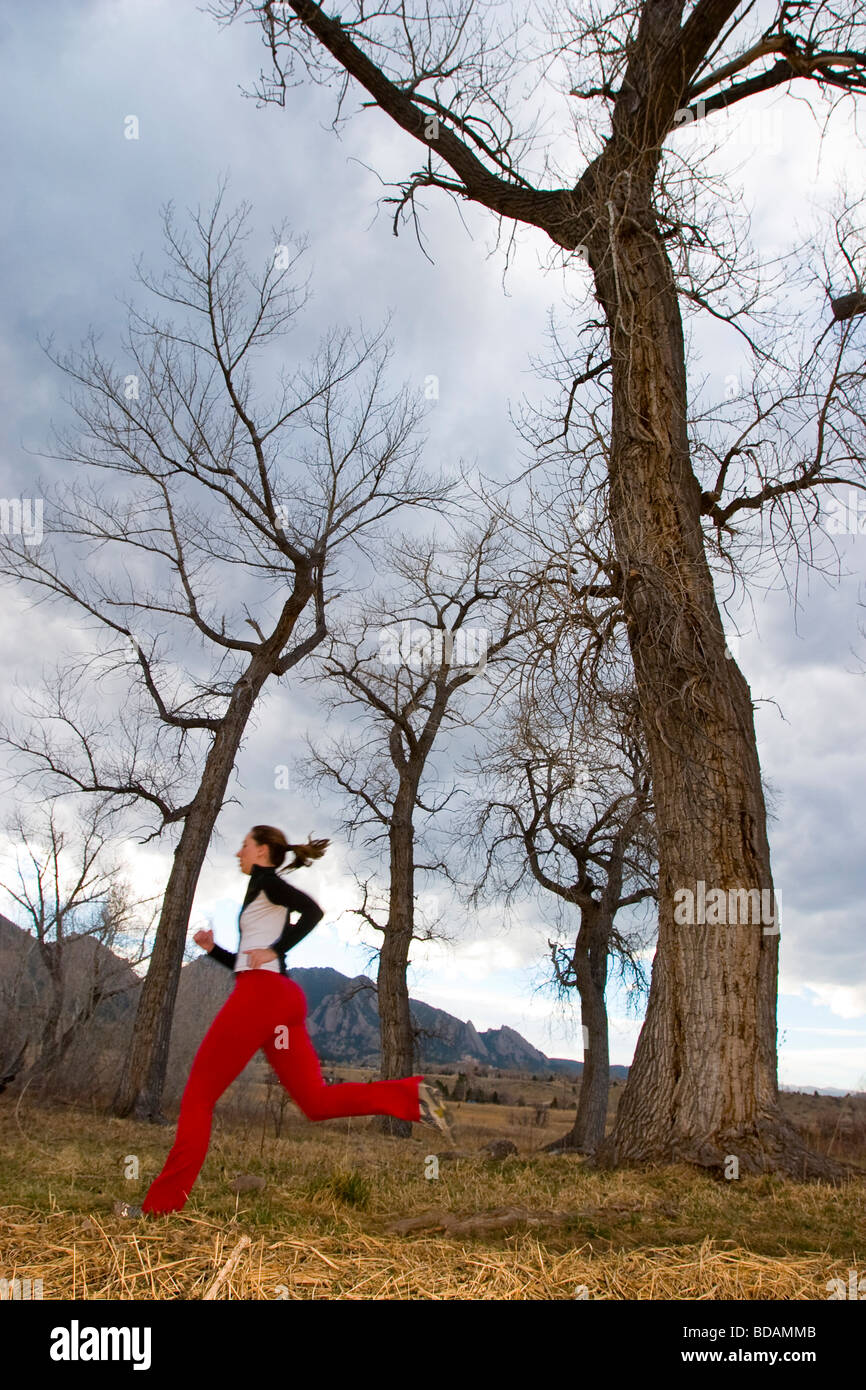 Female runner training on a dirt trail near South Boulder Creek in ...