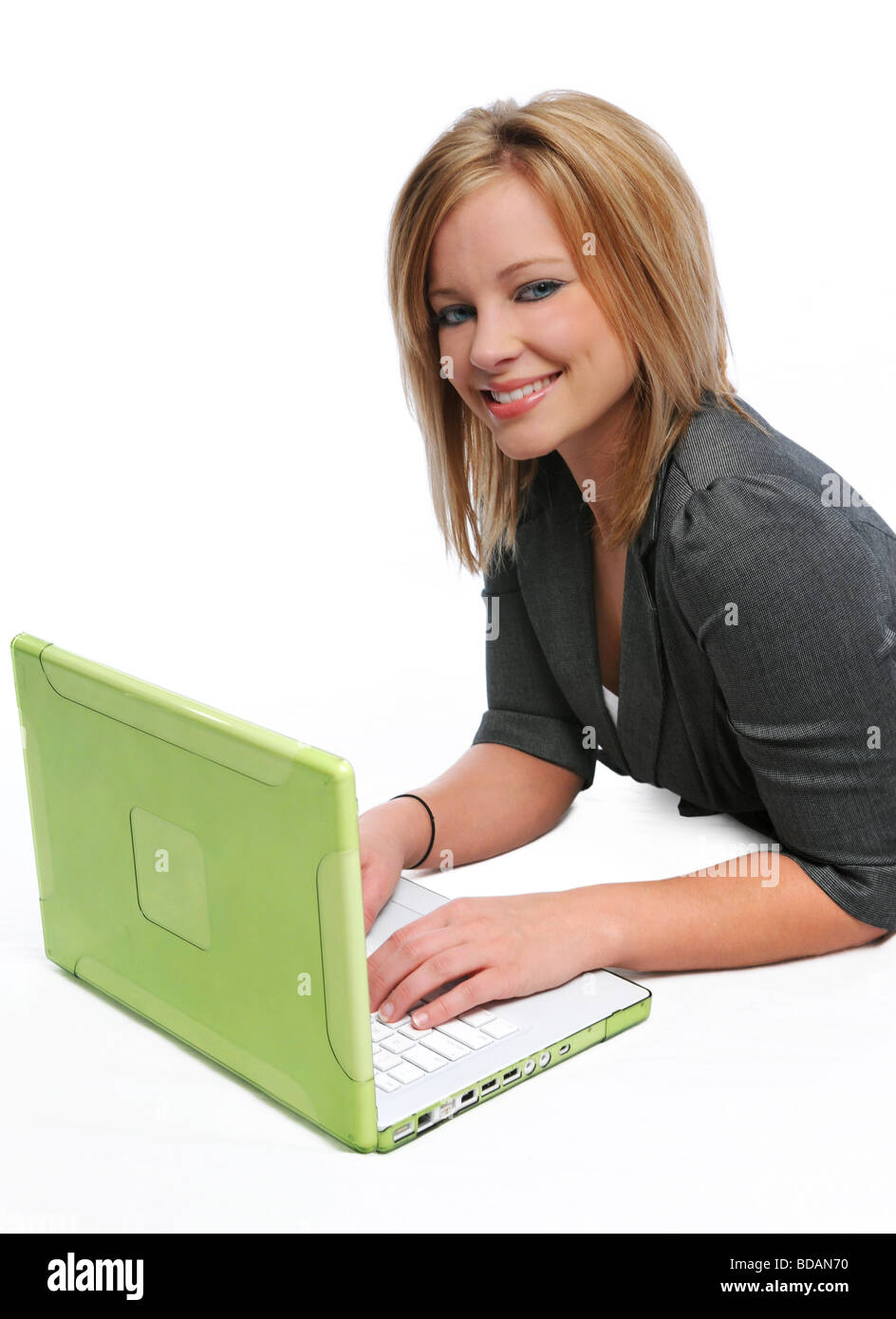 Young businesswoman with laptop lying on the floor Stock Photo - Alamy