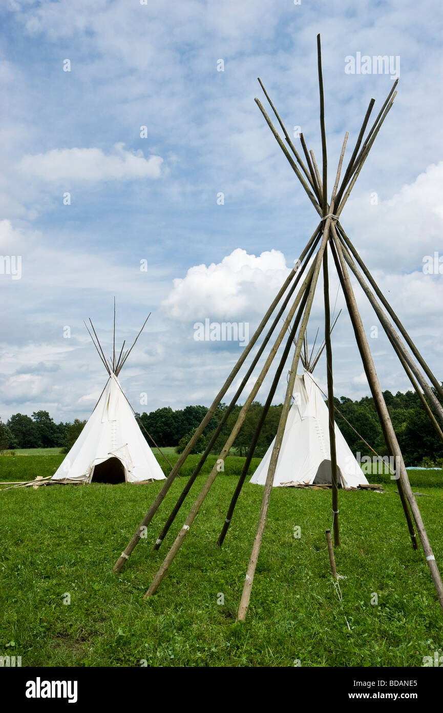 Frame of a tee-pee and two tee-pees behind on a meadow Stock Photo - Alamy