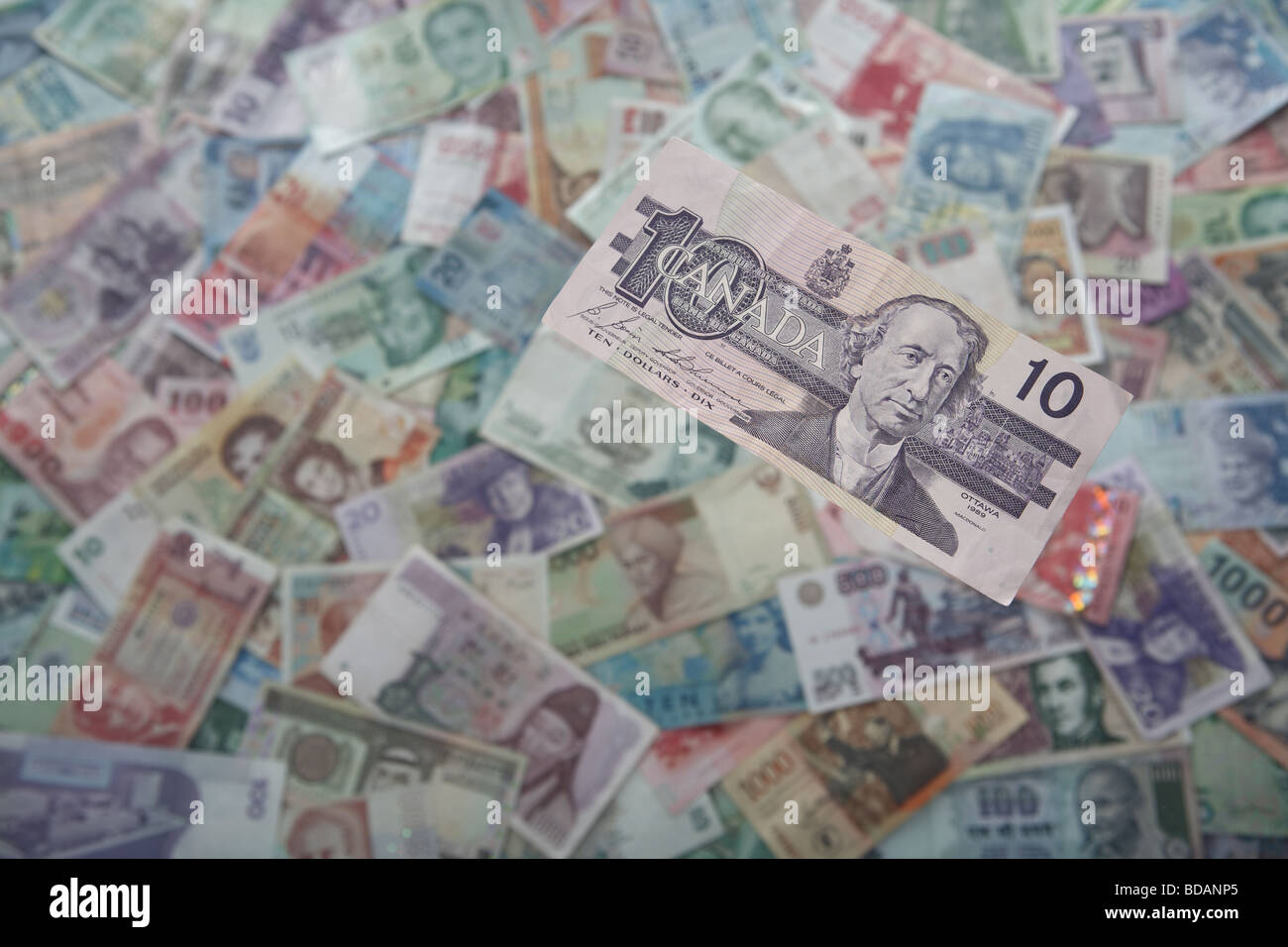 A Canadian Dollar on a soft background of international currencies ...