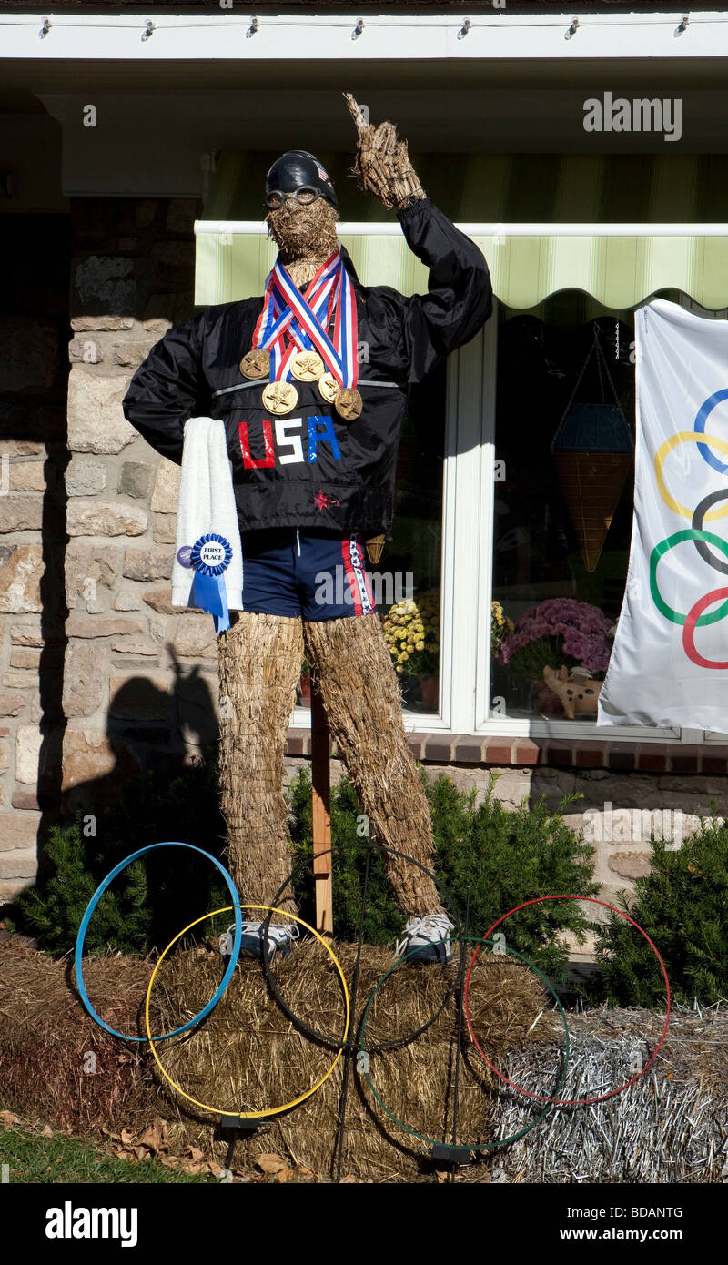 A scarecrow done as an Olympic swimmer. Five gold medals, swim trunks ...
