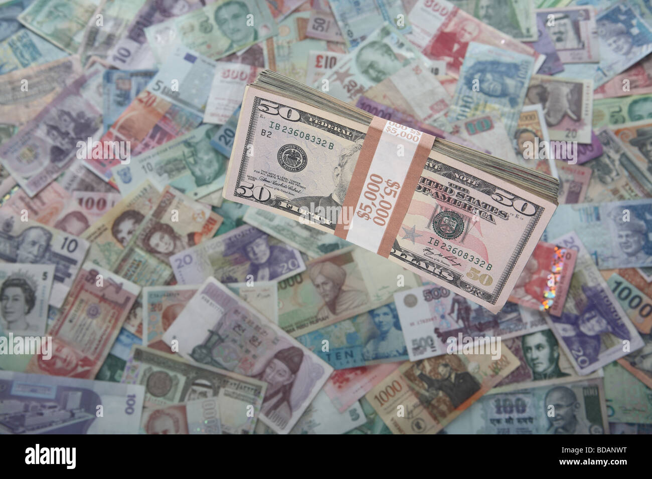 A bundled stack of fifty dollar bills on a soft background of ...